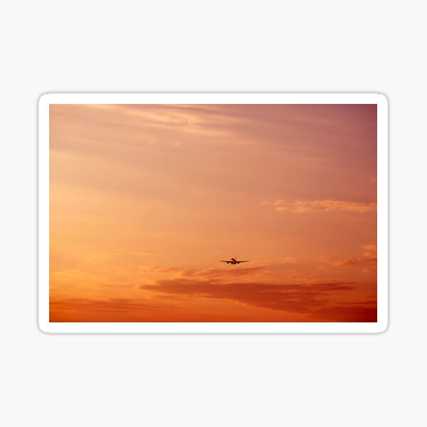 "Airplane taking off and flying high in sunset sky" Sticker for Sale by ...