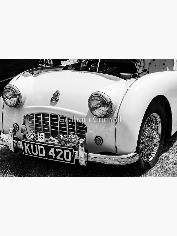 "A black and white image of the front of a 1950's Triumph TR3 on ...