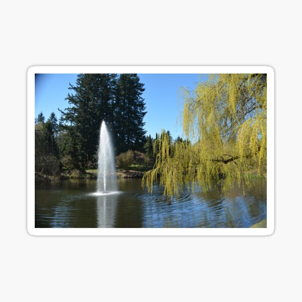 "Beautiful spring garden with willow tree by a pond and water fountain ...