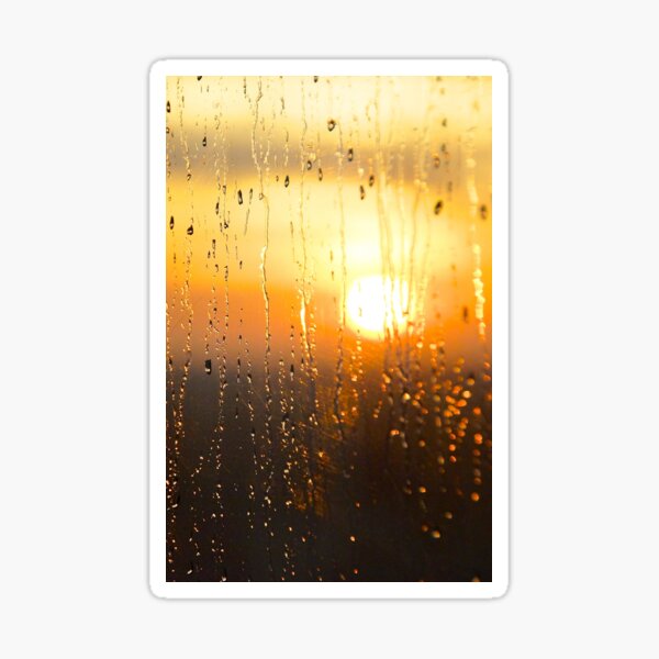 "rain droplets sliding down the window with a sunset view" Sticker for ...