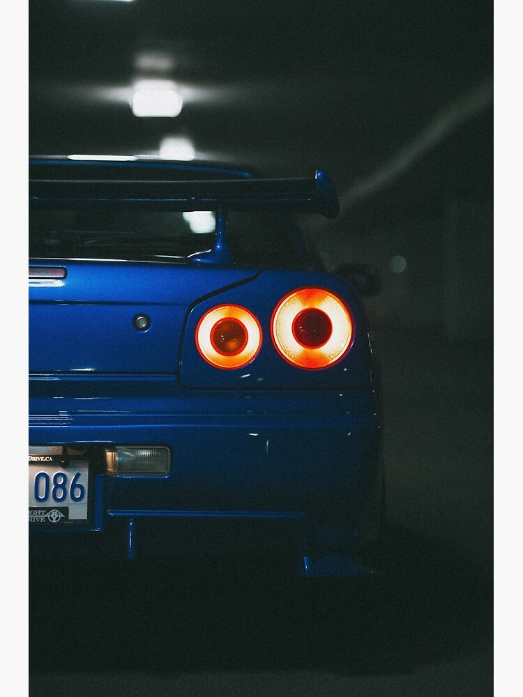 "blue r34 nissan gtr rear lights at night in parking garage ...