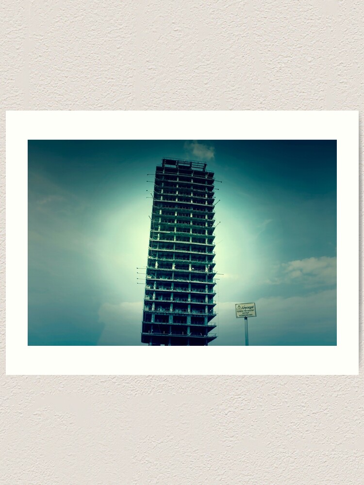 "Old unfinished building called "Skeleton". Yellow sign with the words ...