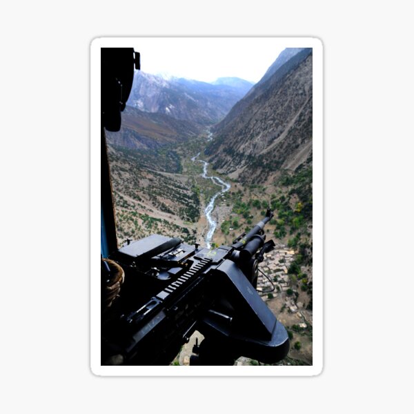 "An aerial gunner surveys the surrounding area during a combat mission ...