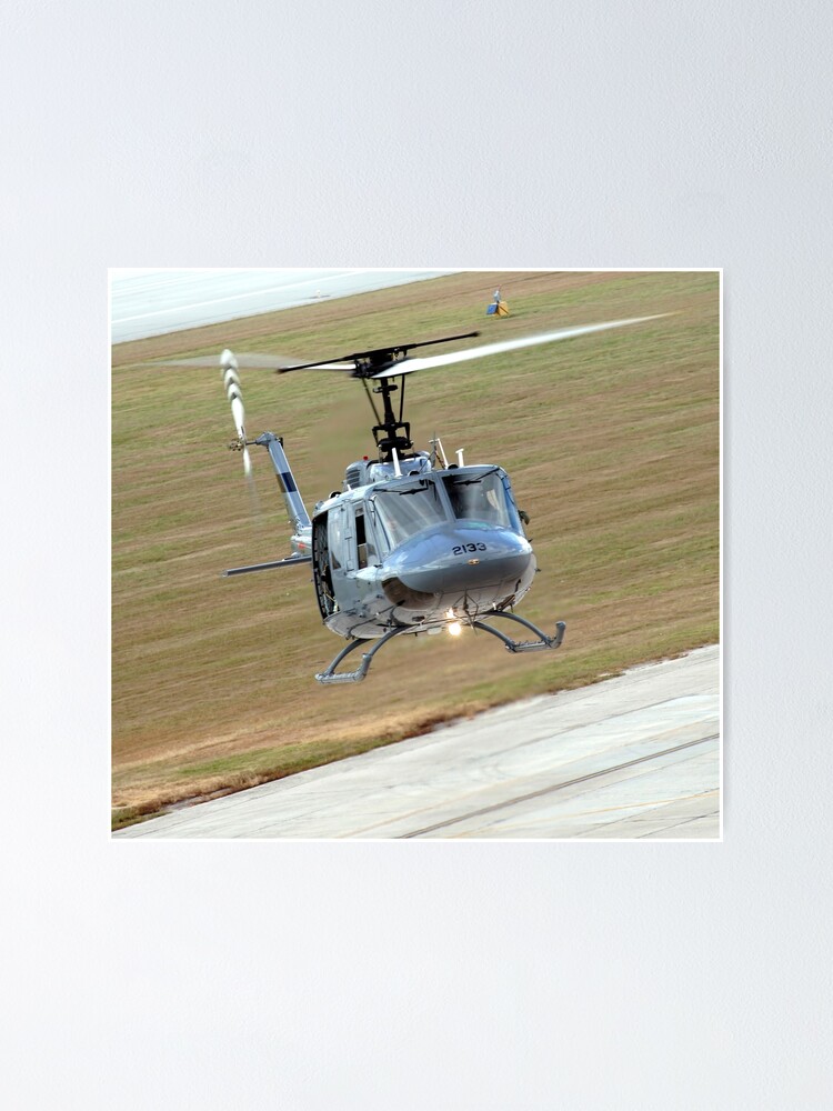 "Captain pilots the TH-1H trainer helicopter with instructor pilot ...