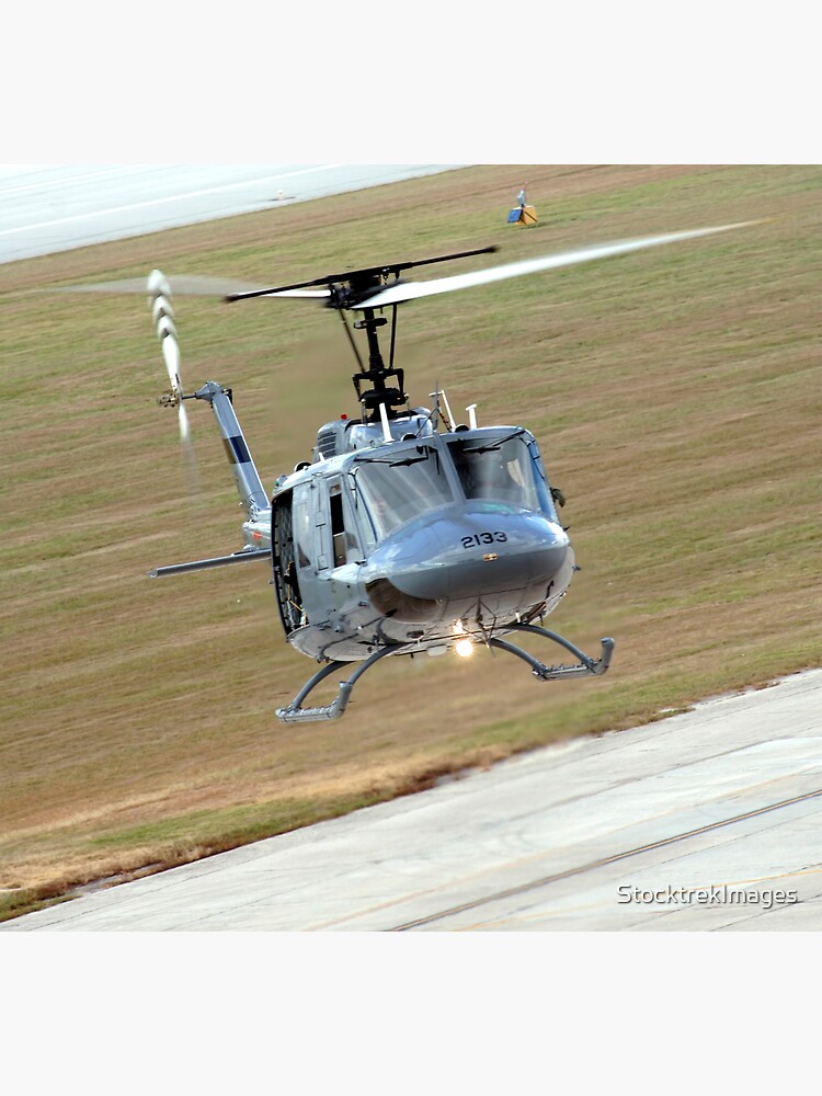 "Captain pilots the TH-1H trainer helicopter with instructor pilot ...