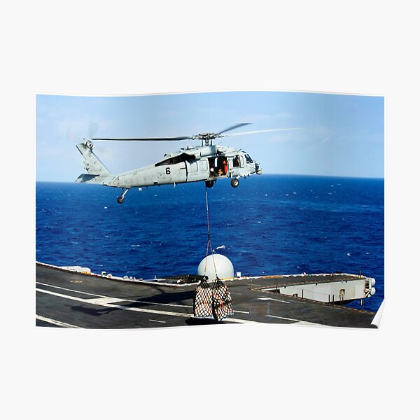 "An MH-60R Seahawk helicopter places cargo onto the flight deck of USS ...
