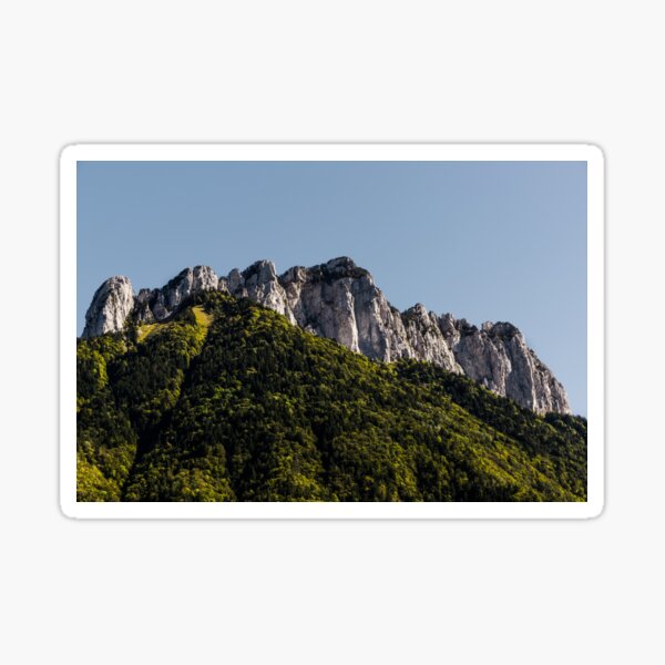 "A rocky mountain above a dense green forest in Annecy" Sticker for ...