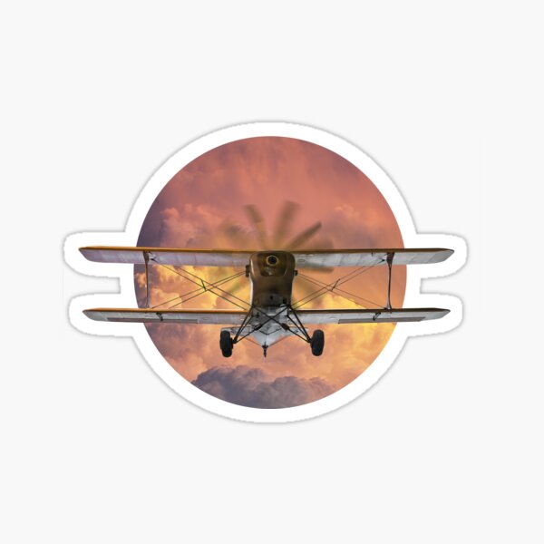 "Biplane with Brilliant Storm Clouds at Sunset" Sticker for Sale by ...