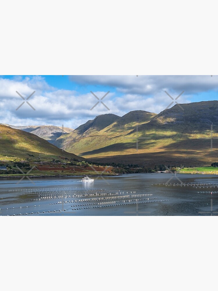"A ship sailing in an Atlantic bay between majestic mountains in ...