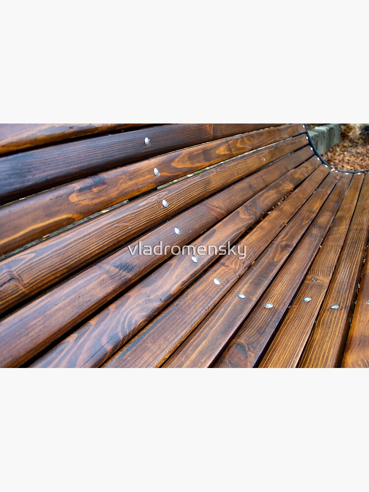 "Angled view of a park bench with natural wood texture close up ...
