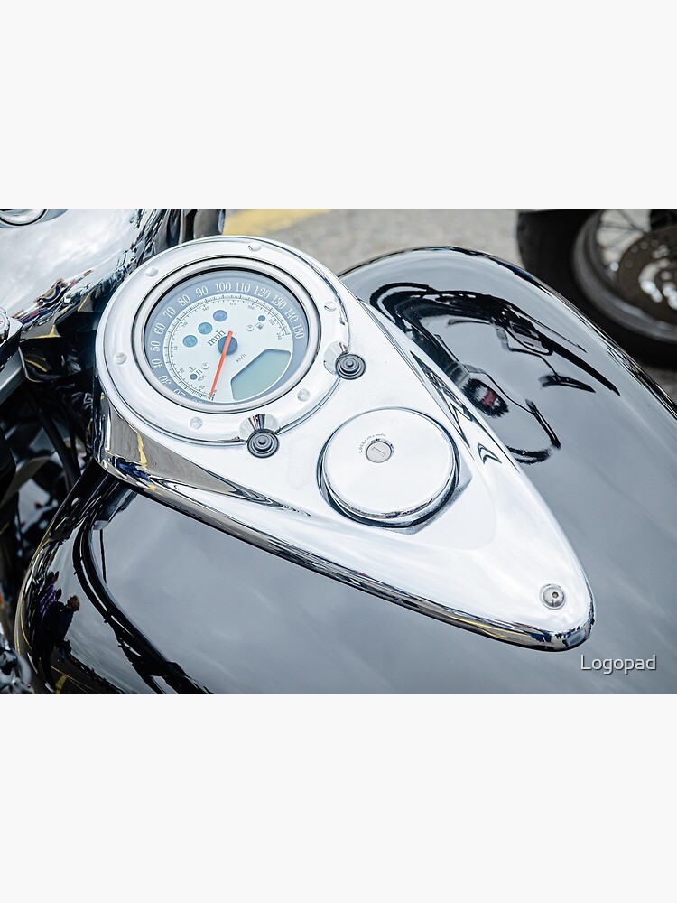 "A motorcycle instrument panel mounted on the vehicle’s fuel tank ...